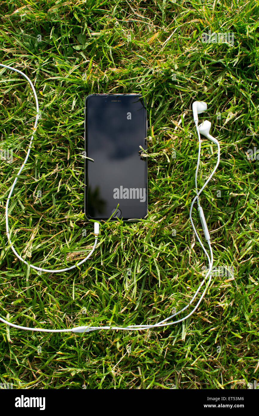 Phone with headset on the grass Stock Photo - Alamy