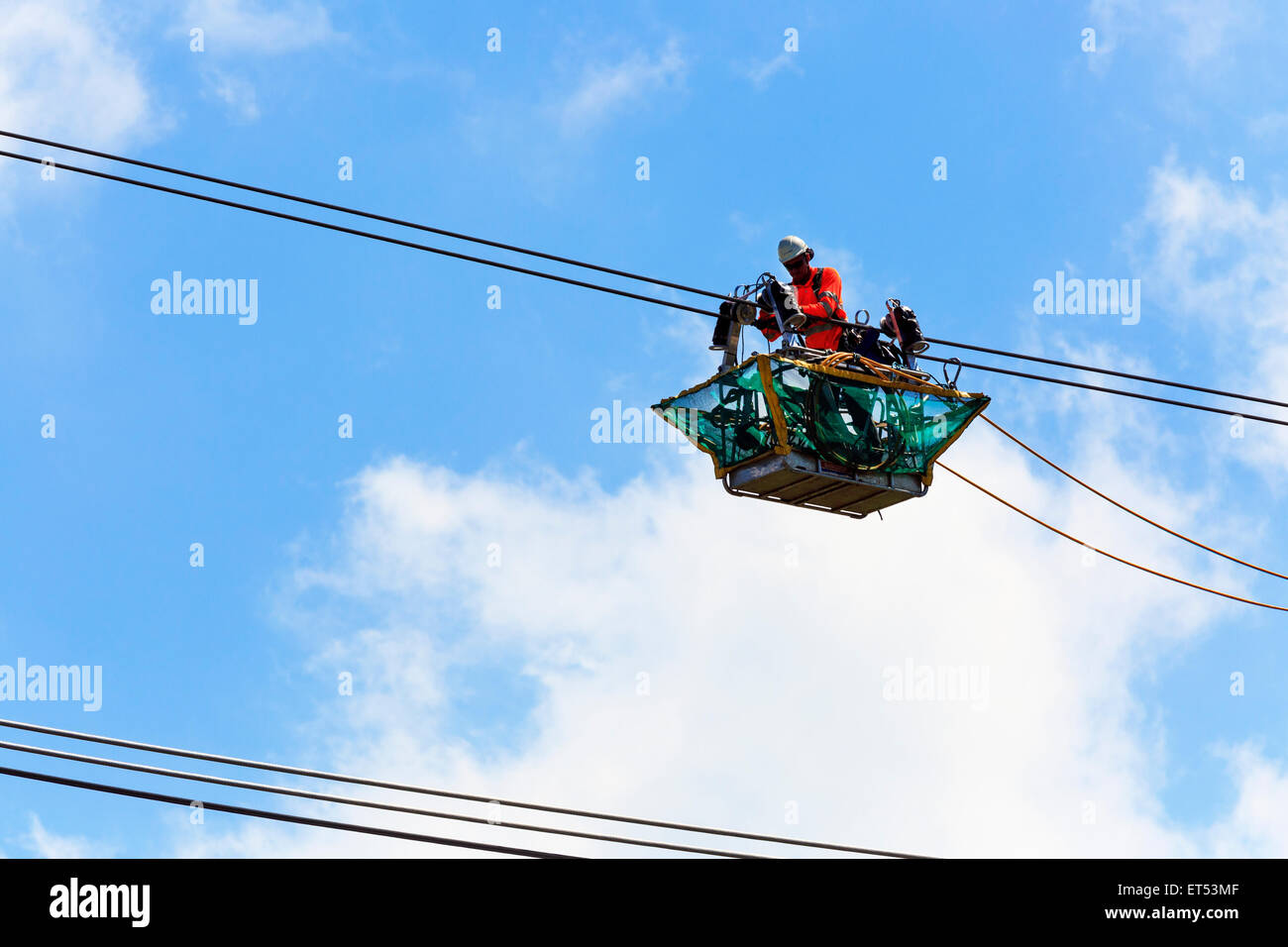 Engineer working on a high voltage power line near Glasgow, Scotland ...