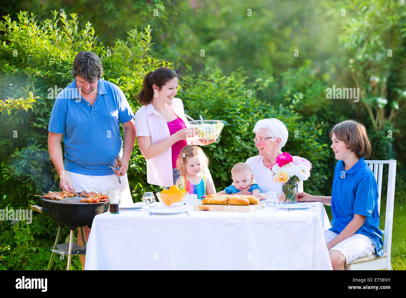 Grill barbecue backyard party. Happy big family enjoying BBQ lunch with ...