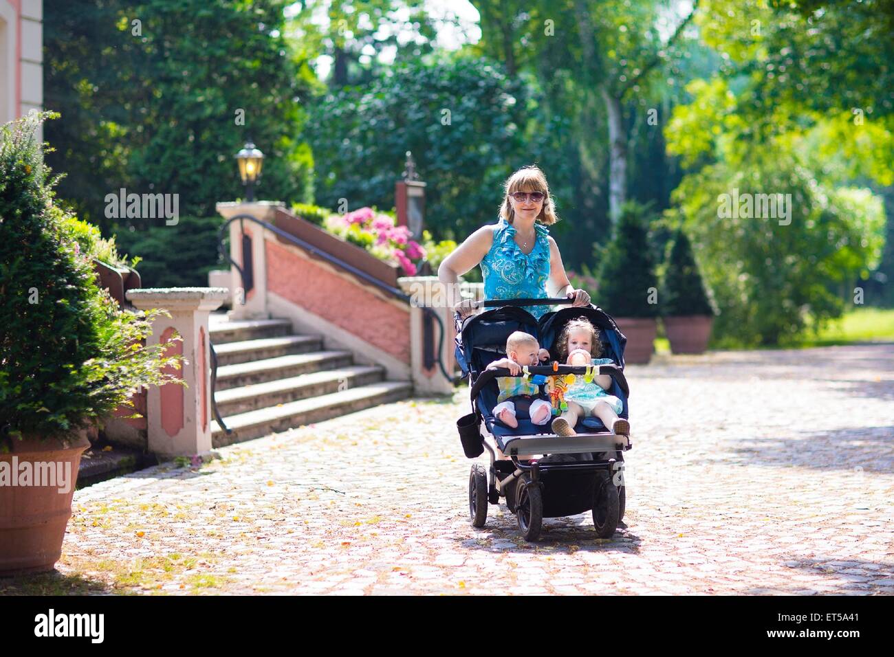 Woman with a double stroller Stock Photo - Alamy