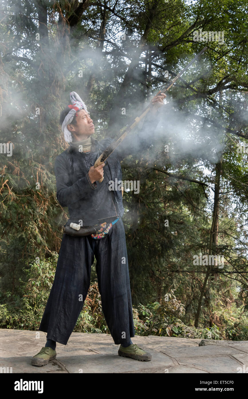 Basha ethnic Miao man firing his gun, Basha Gun Village, Guizhou ...