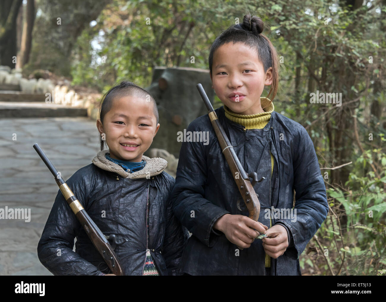 Two Miao boys with topknots and flintlock pistols, Basha Gun Village ...