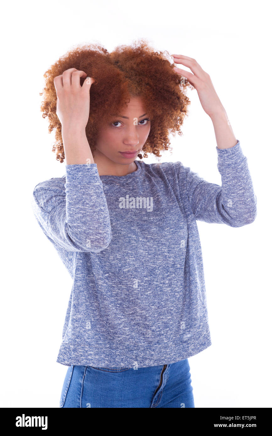 Young african american teenage girl holding her curly tangled hair ...