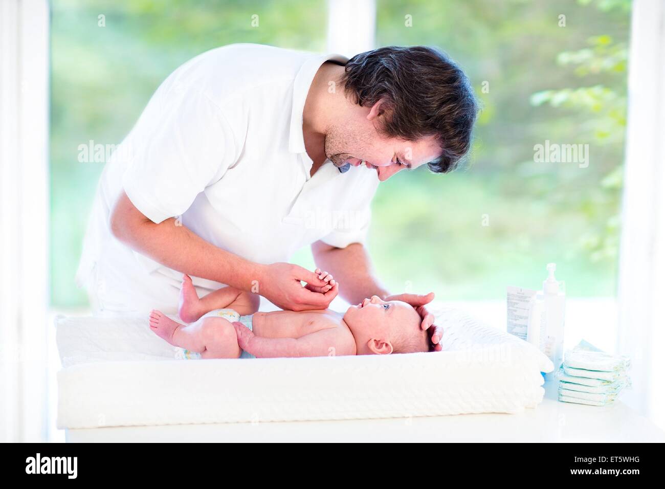 Young man changing baby diaper hi-res stock photography and images - Alamy