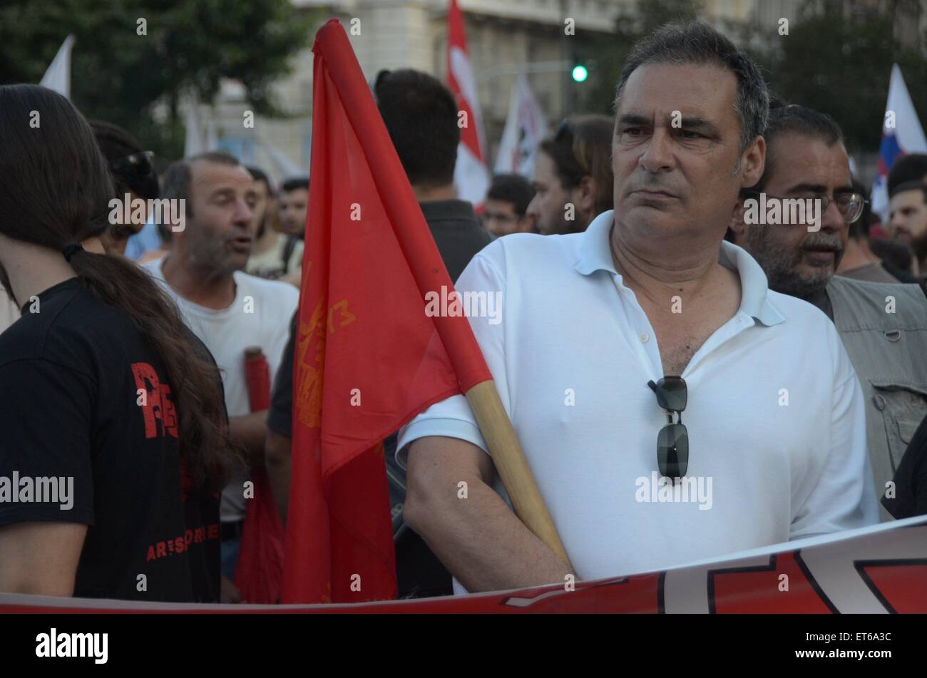 Athens, Greece. 11th June, 2015. A demonstrator holds a big Red flag ...
