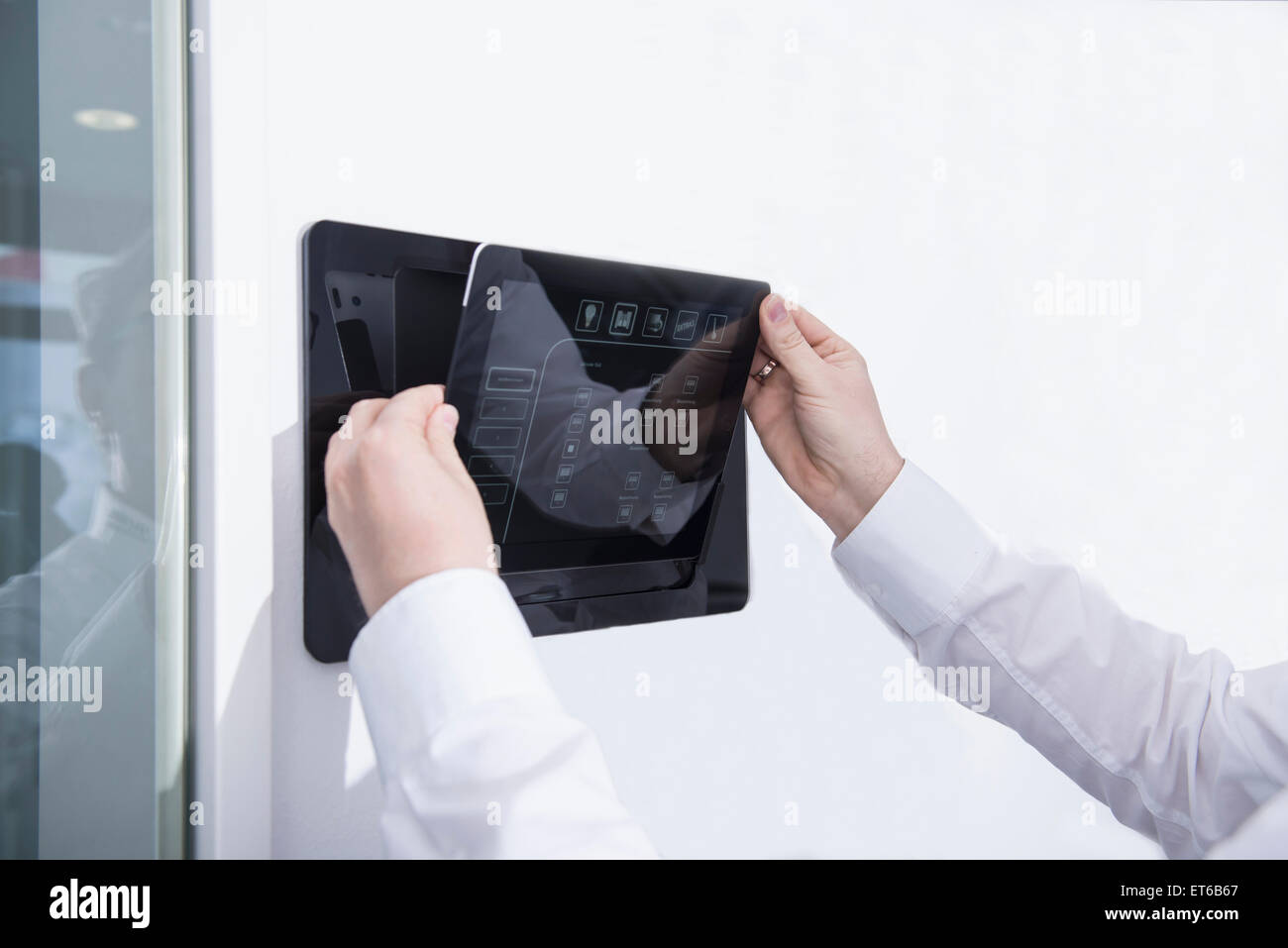 Man operating control panel on wall mounted, Munich, Bavaria, Germany ...