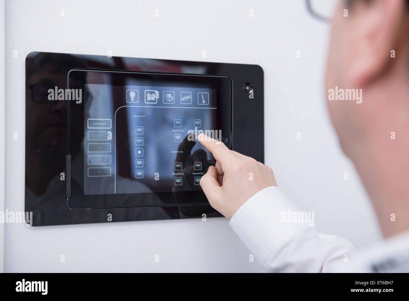 Man operating Control panel on wall mounted, Munich, Bavaria, Germany ...