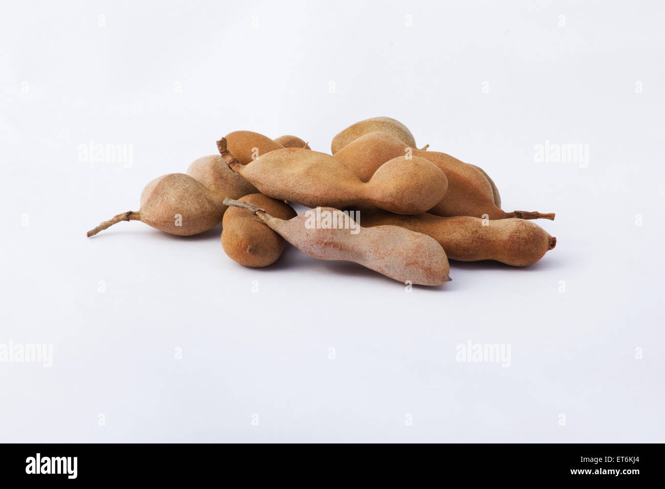 Tamarind (Tamarindus indica) fruit on white background Stock Photo - Alamy