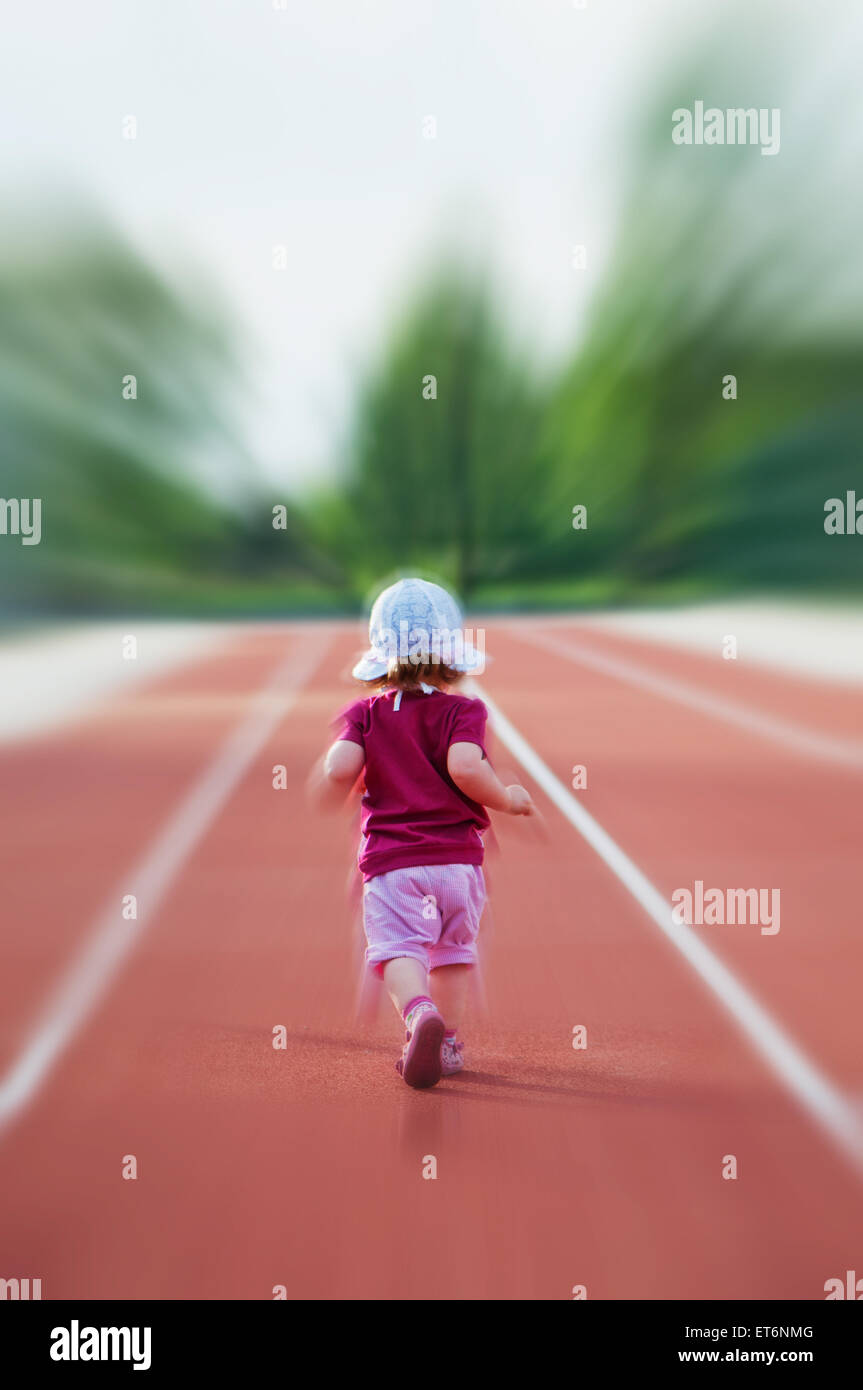 little girl runs across the track Stock Photo - Alamy