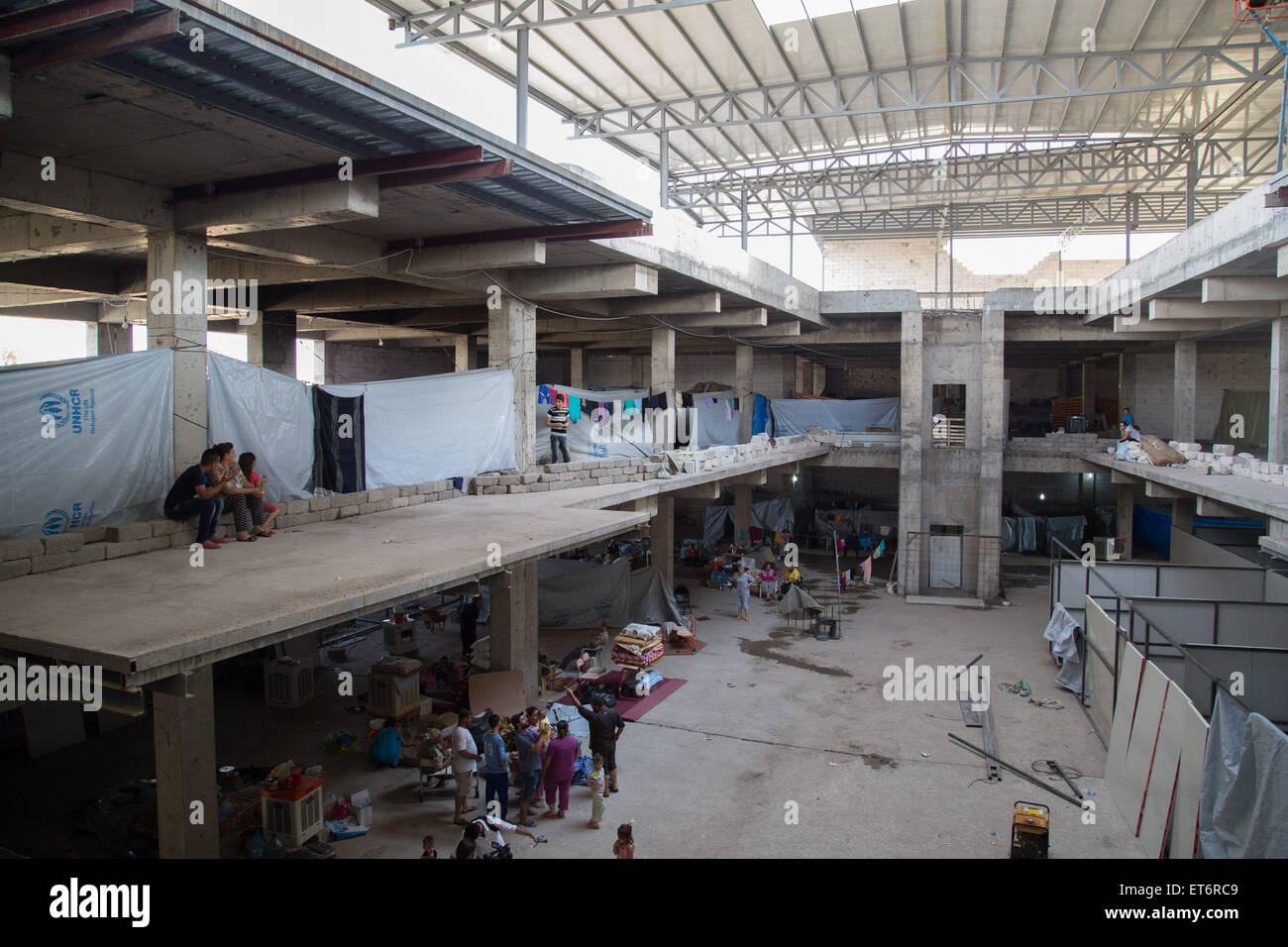 Iraqi Christians take shelter in an empty construction site in Erbil ...