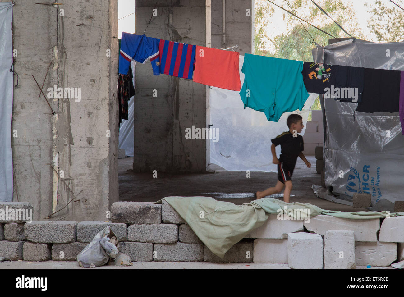 Iraqi Christians take shelter in an empty construction site in Erbil ...