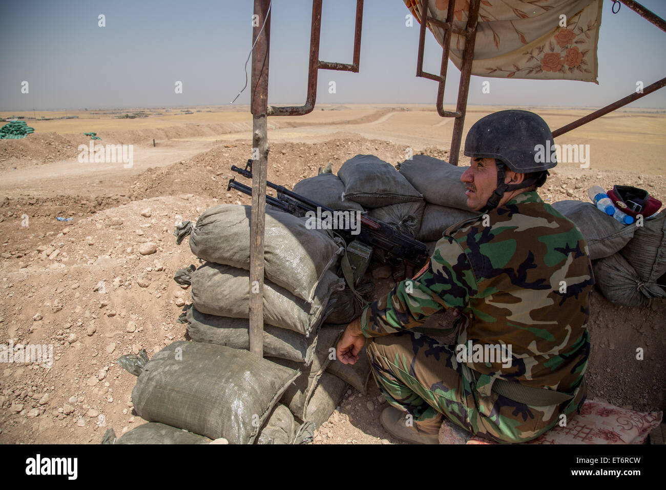 Peshmerga fighters stand ready at the Al Rash front line against ISIS ...