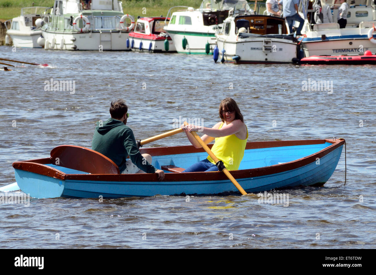 A couple have fun in a rowing boat on the River Thames while in the ...
