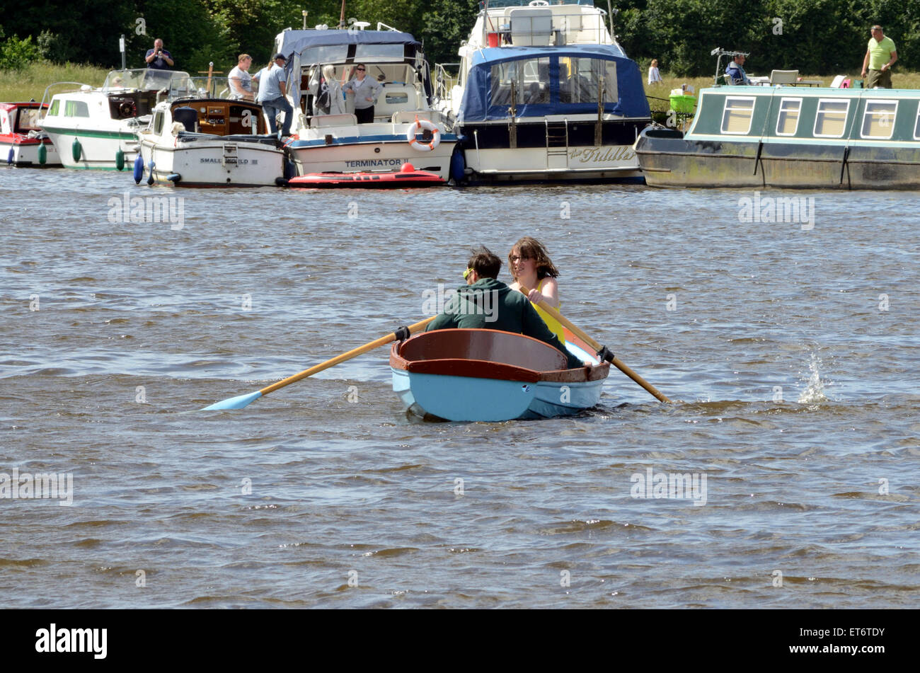 A couple have fun in a rowing boat on the River Thames while in the ...