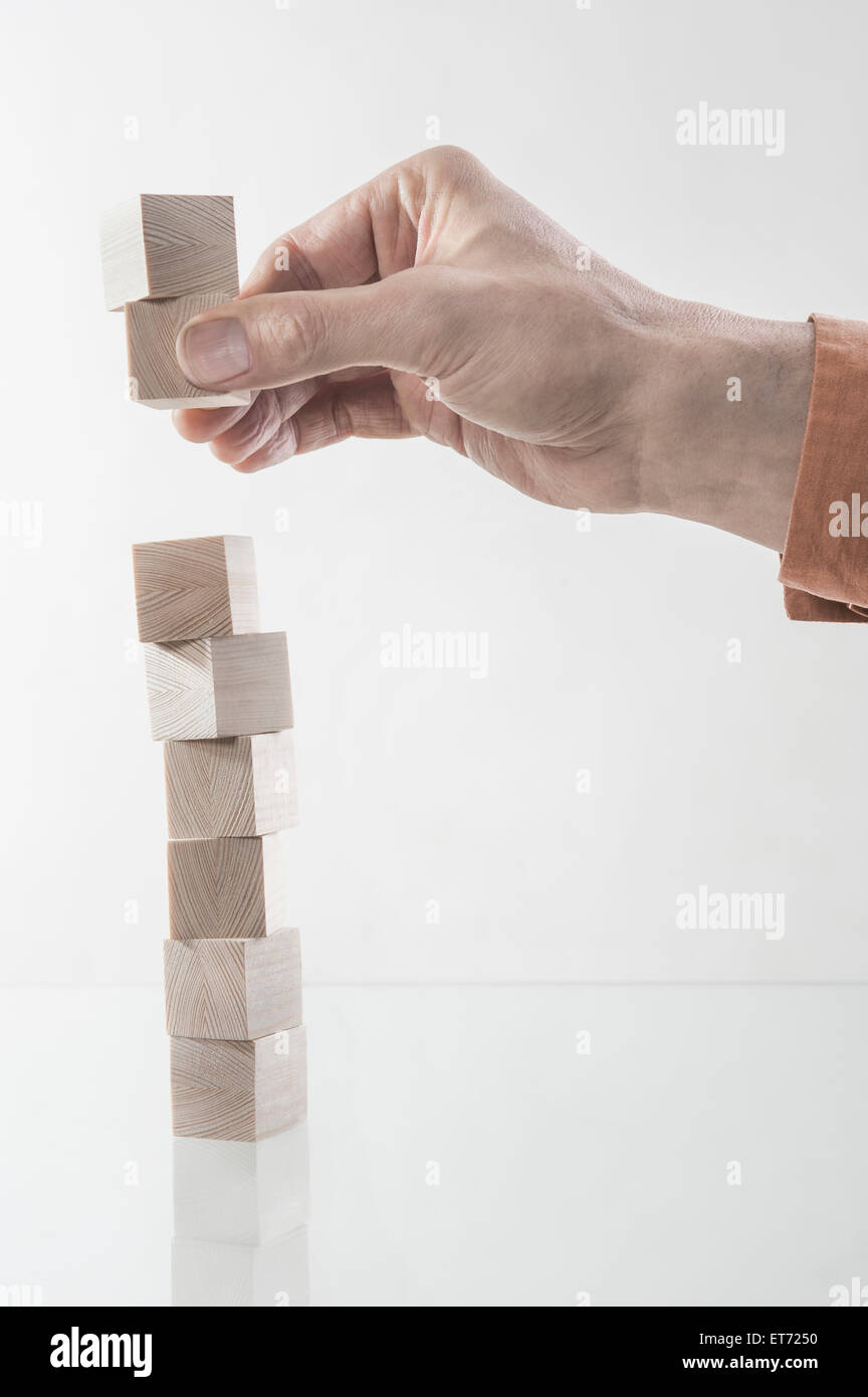 Man's hand stacking wooden building blocks, Bavaria, Germany Stock ...