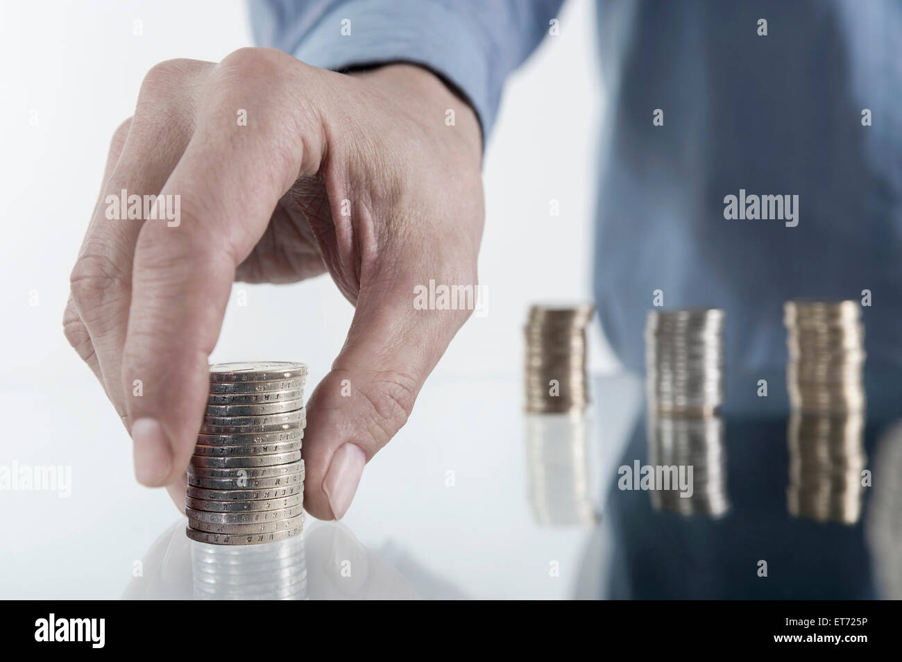 Man stacking coins table hi-res stock photography and images - Alamy