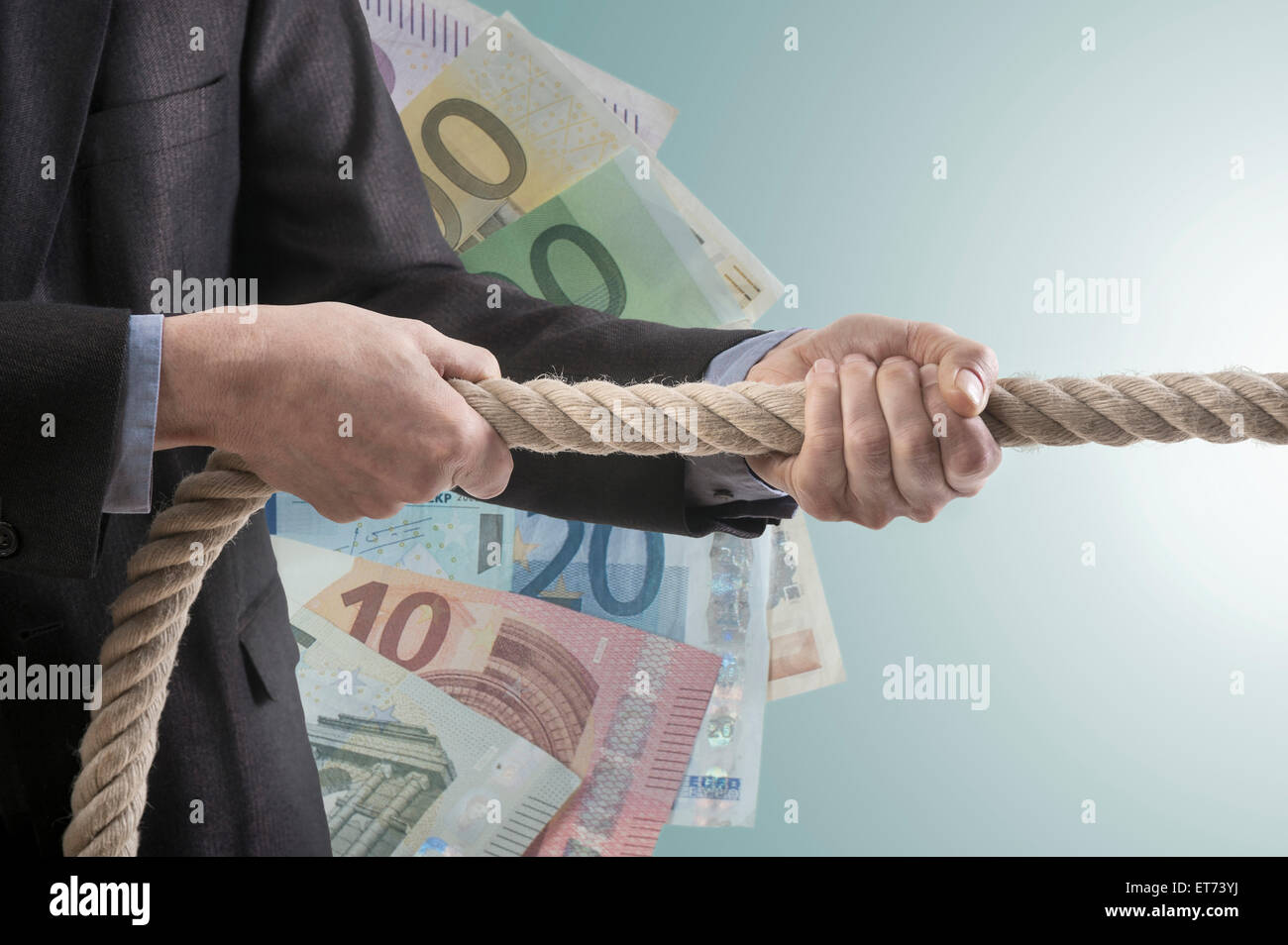 Mid section view of businessman pulling rope, Bavaria, Germany Stock ...