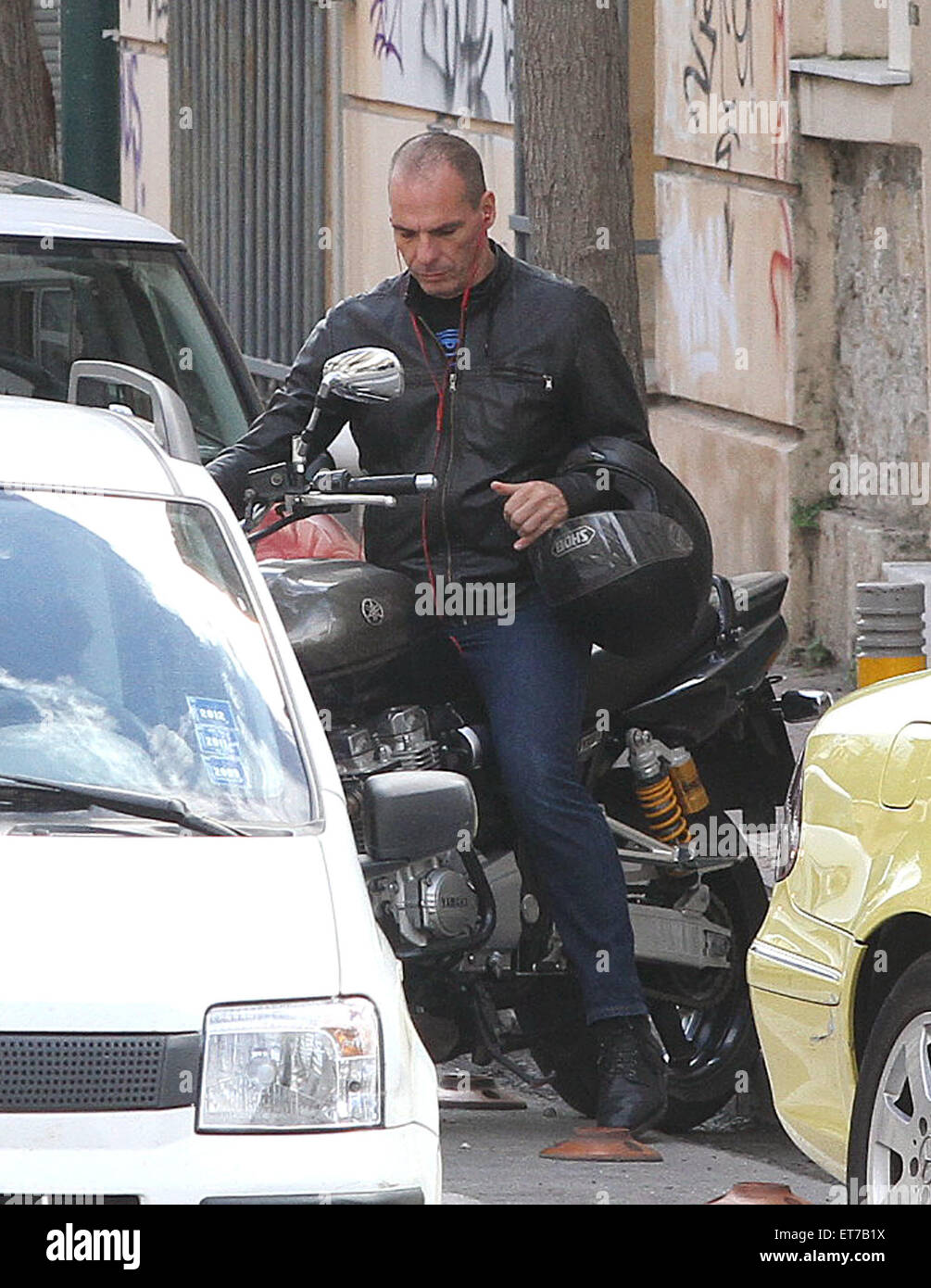 Yanis Varoufakis gets on his motorcycle parked near his home. The Greek ...