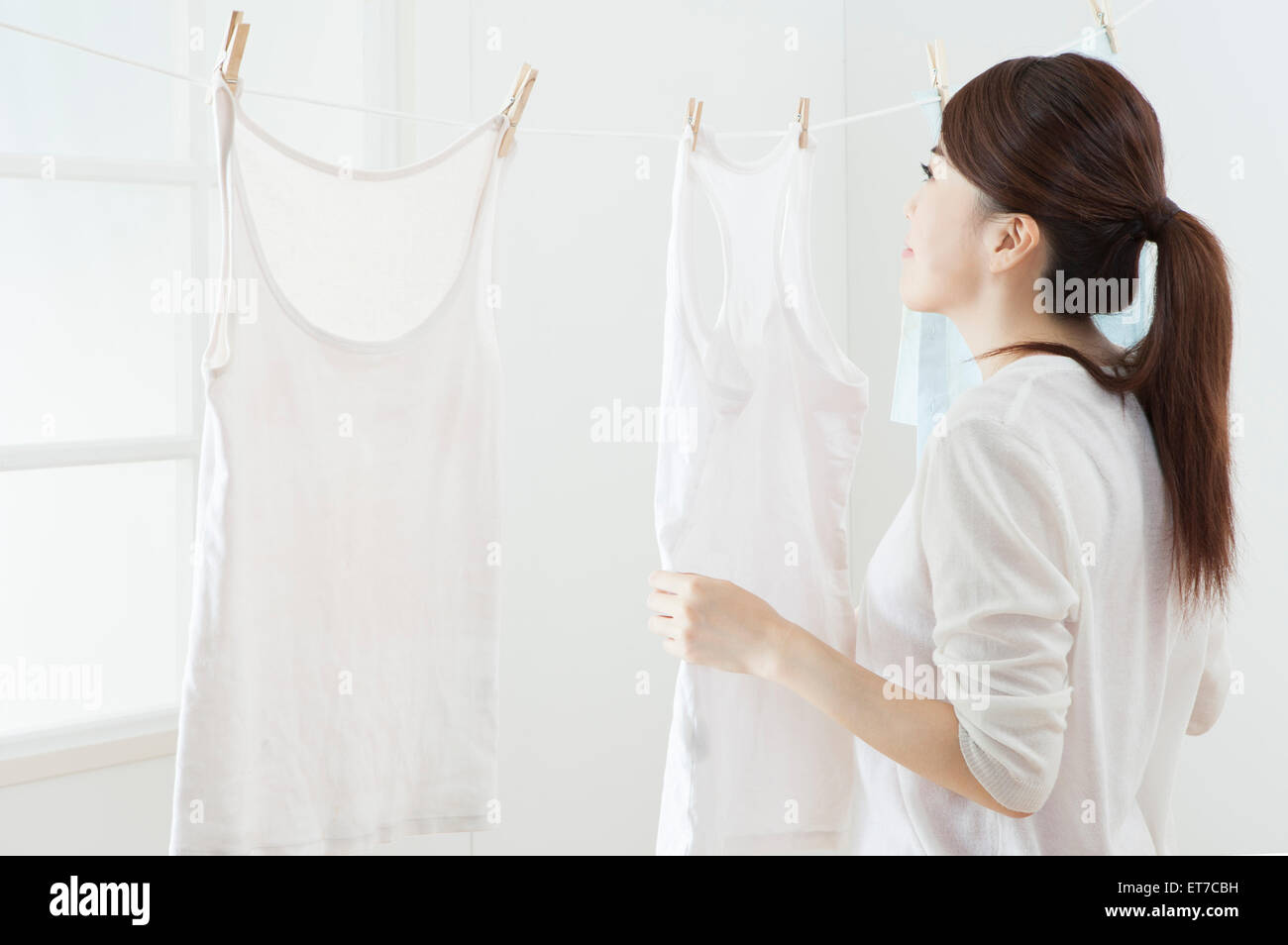 Holding clothes hi-res stock photography and images - Alamy