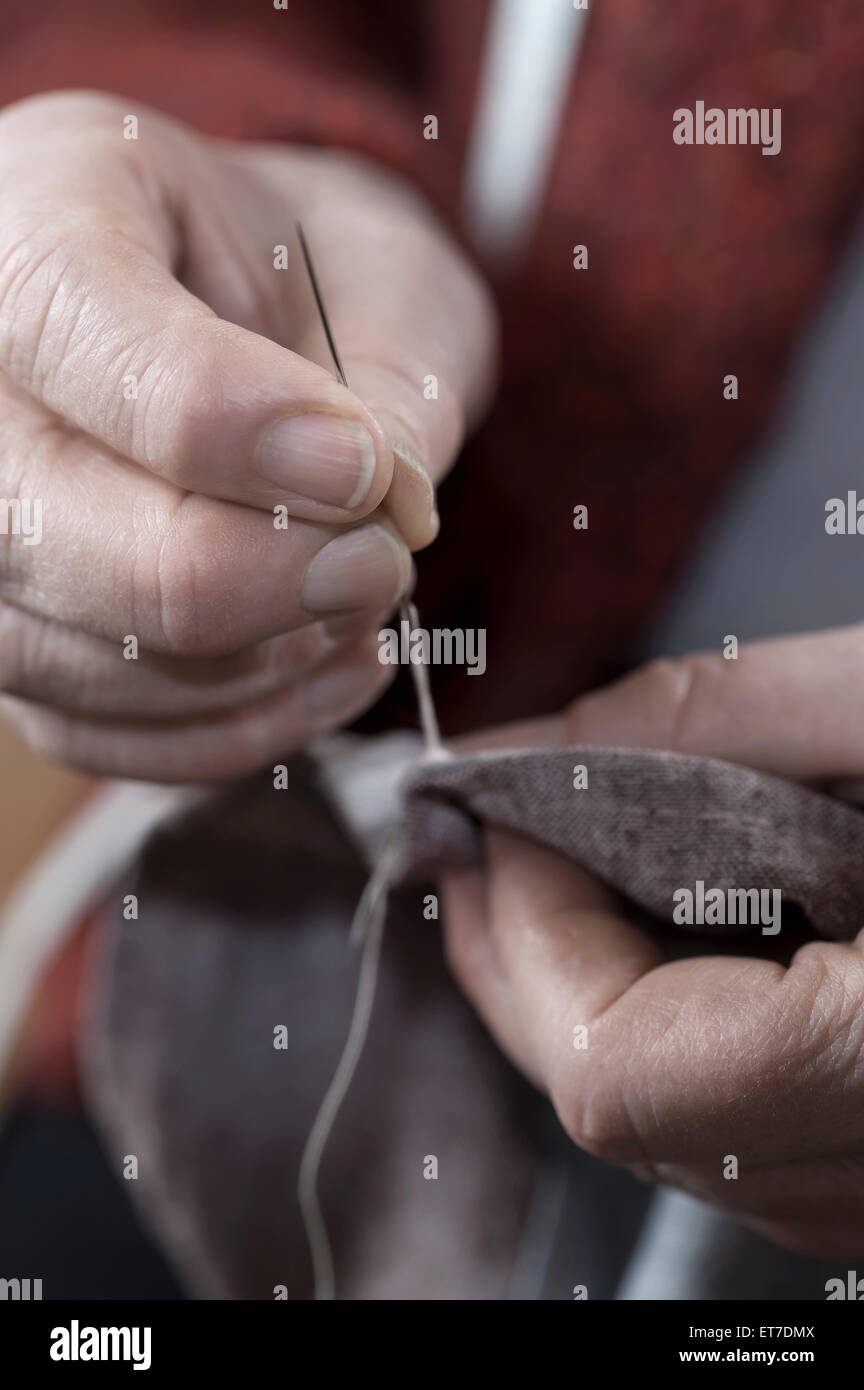 Tailor stitching hi-res stock photography and images - Alamy