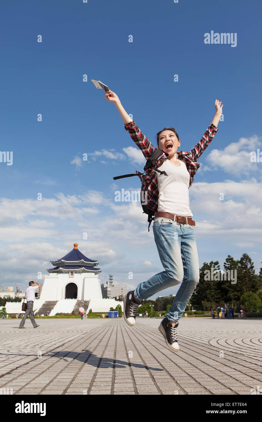 Young woman jumping in mid-air with smile Stock Photo - Alamy
