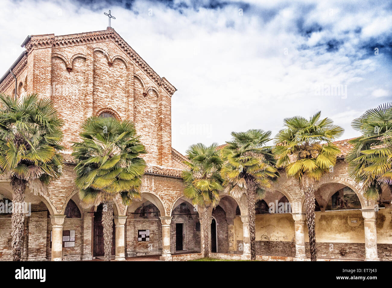 Brickwall facade and colonnade with archs of the XV century roman ...