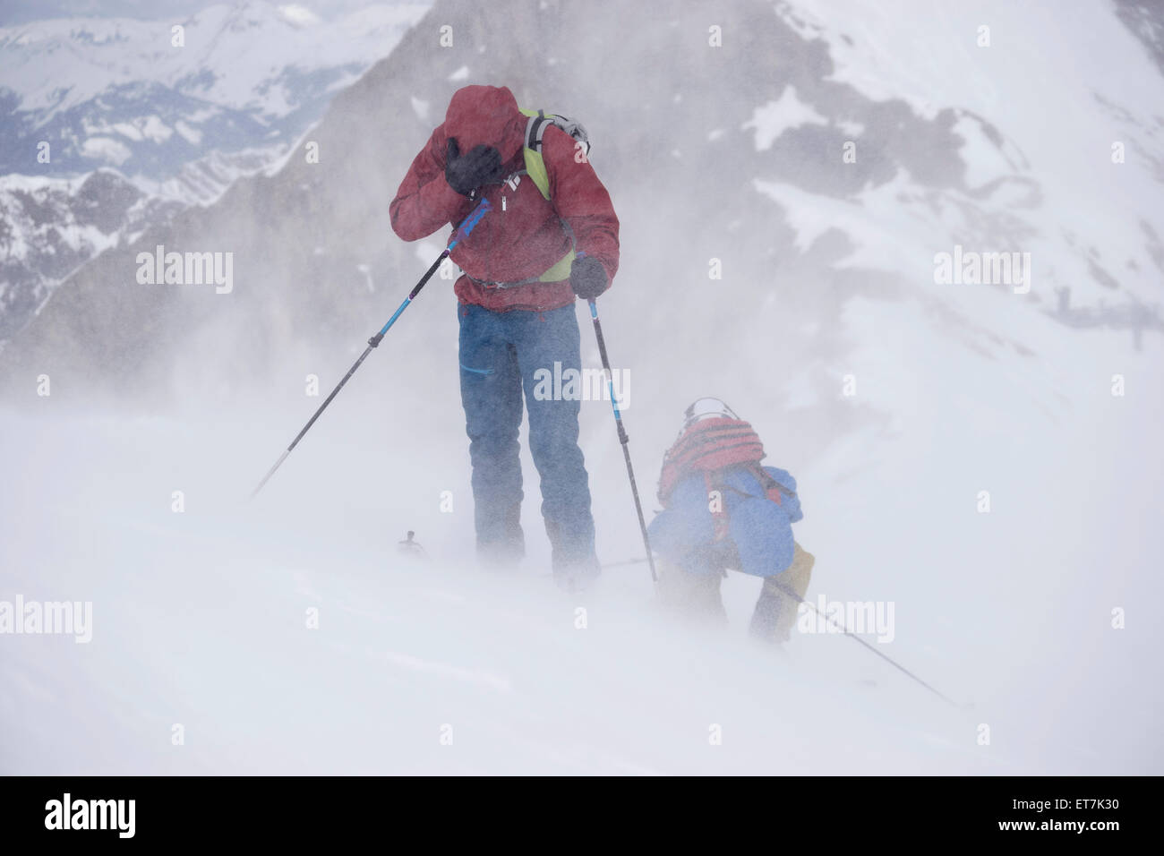Ski mountaineers climbing on snowy mountain in snow storm, Zell Am See ...