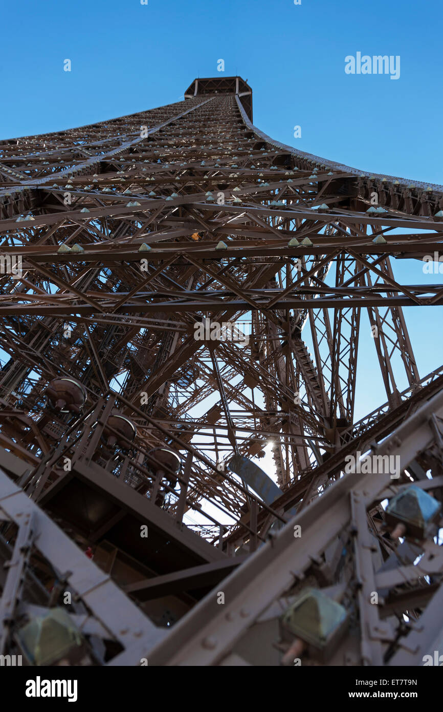 Directly below shot of Eiffel Tower against blue sky, Paris, France ...