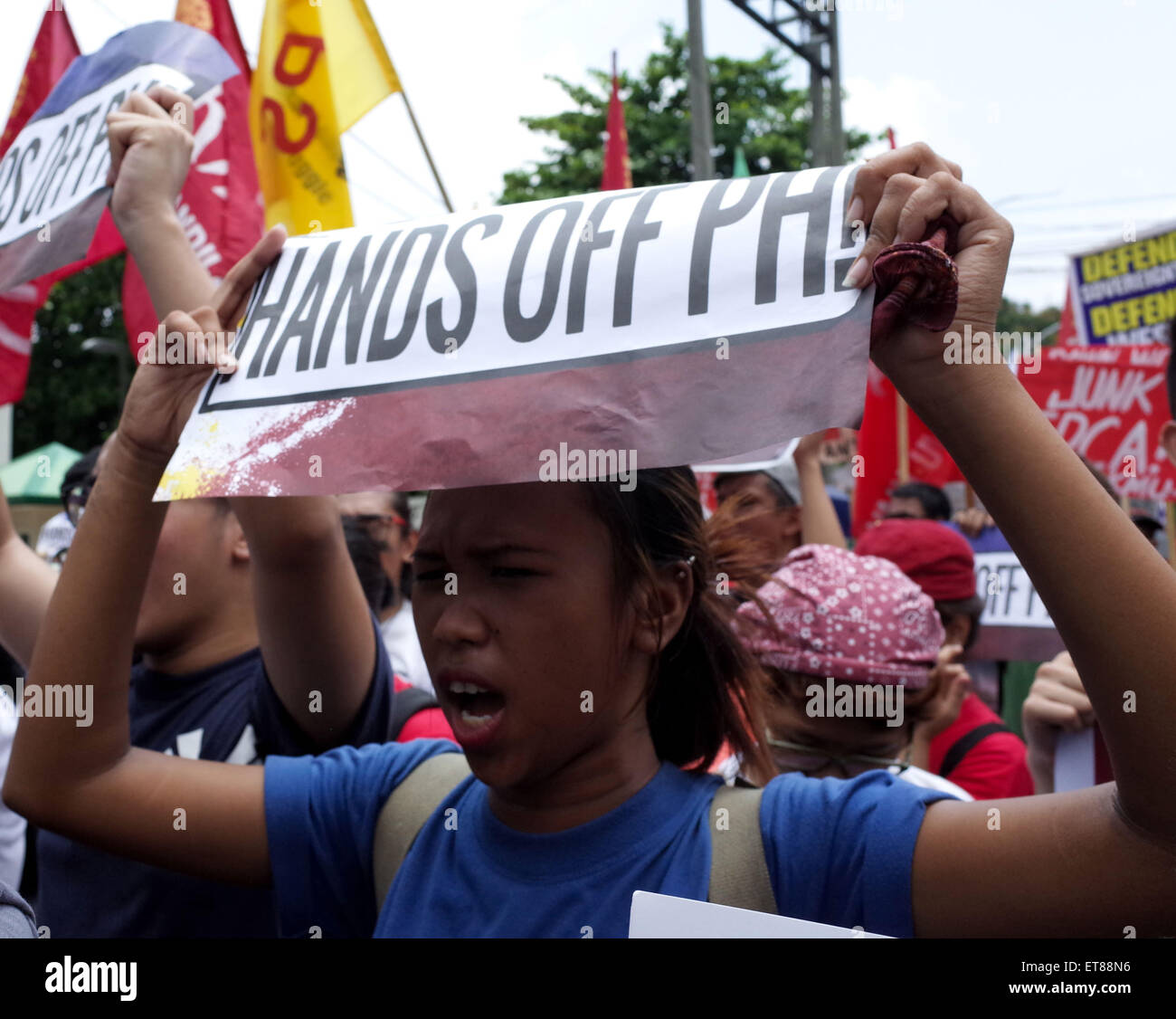 Manila, Philippines. 12th June, 2015. A protester shouts a slogan ...