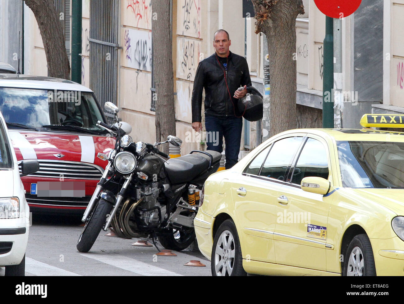 Yanis Varoufakis walks to his motorcycle parked near his home. The ...