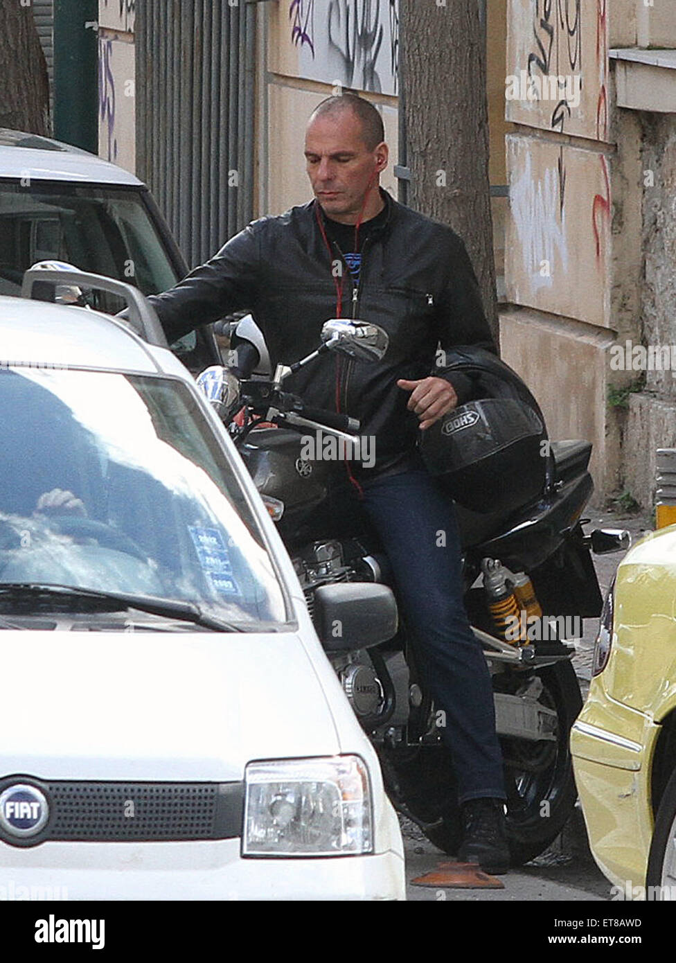 Yanis Varoufakis gets on his motorcycle parked near his home. The Greek ...