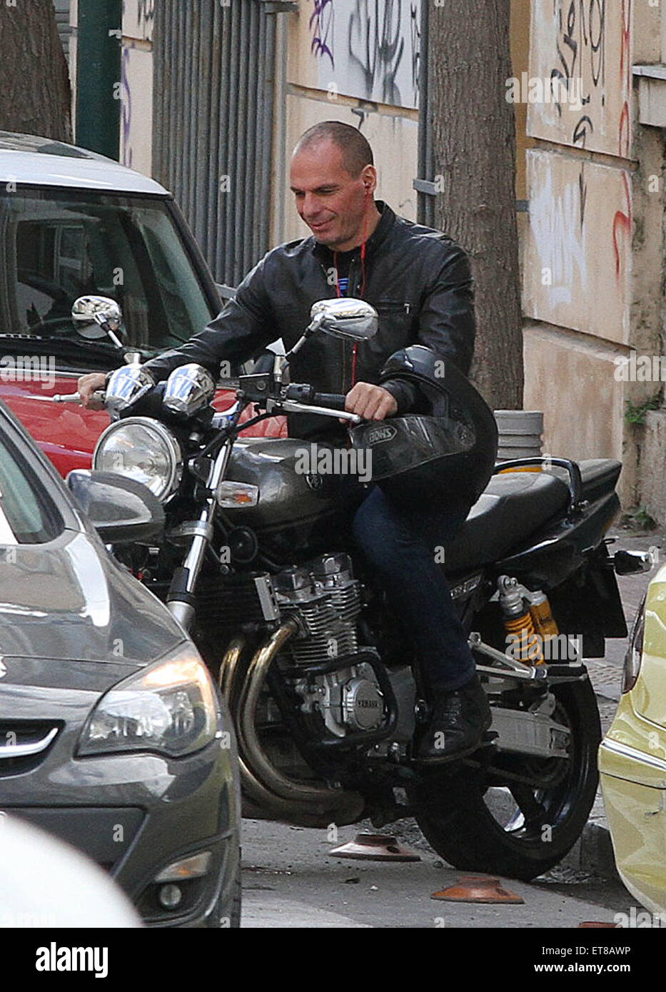Yanis Varoufakis gets on his motorcycle parked near his home. The Greek ...