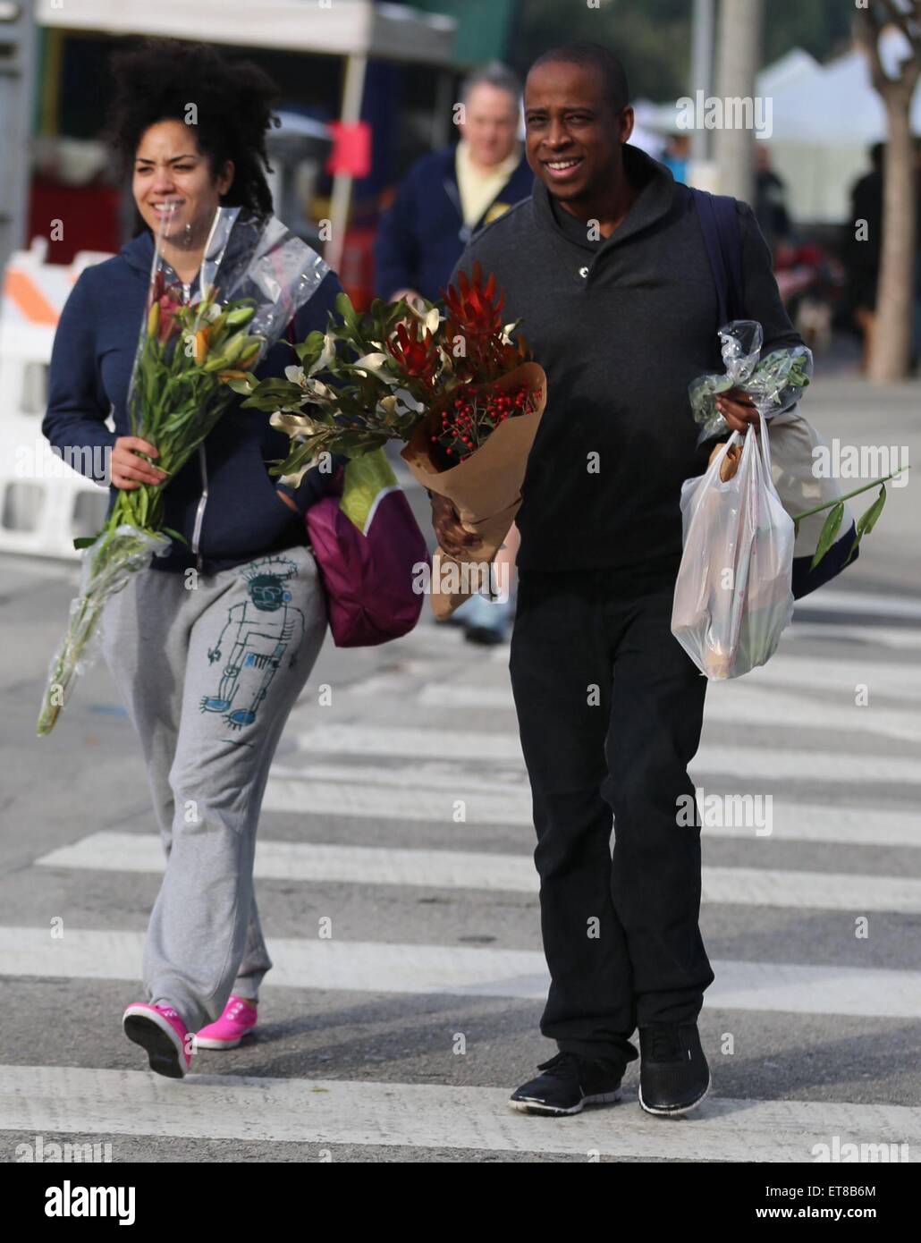 Keith Powell and his wife, Jill Knox purchase flowers from the Farmer's ...