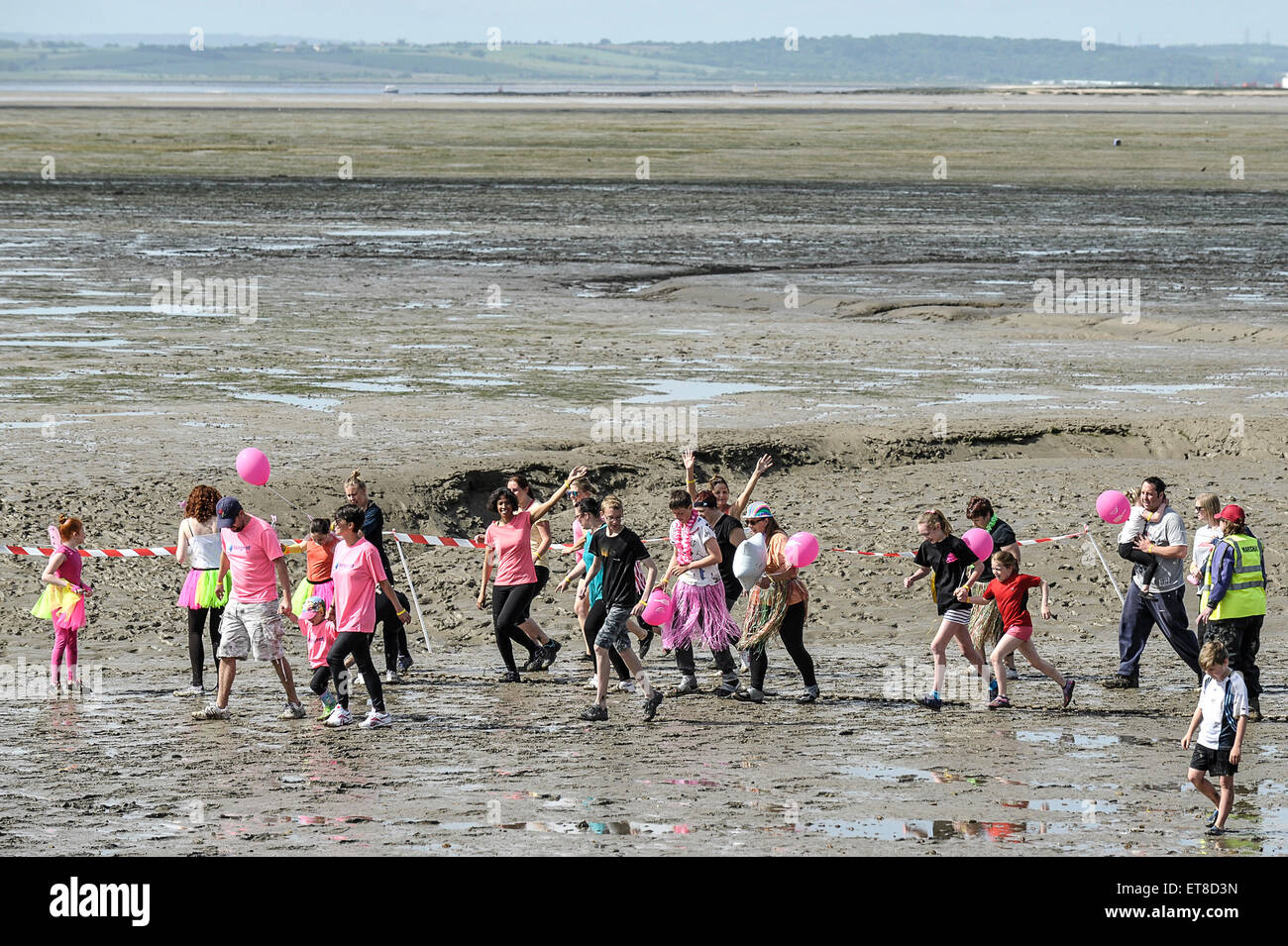 A charity fun run across the muddy foreshore at Leigh on Sea Stock ...