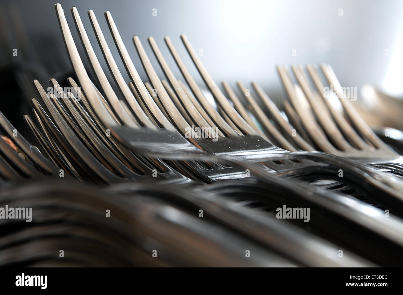 Silver metal forks lying on the kitchen table in daylight Stock Photo ...