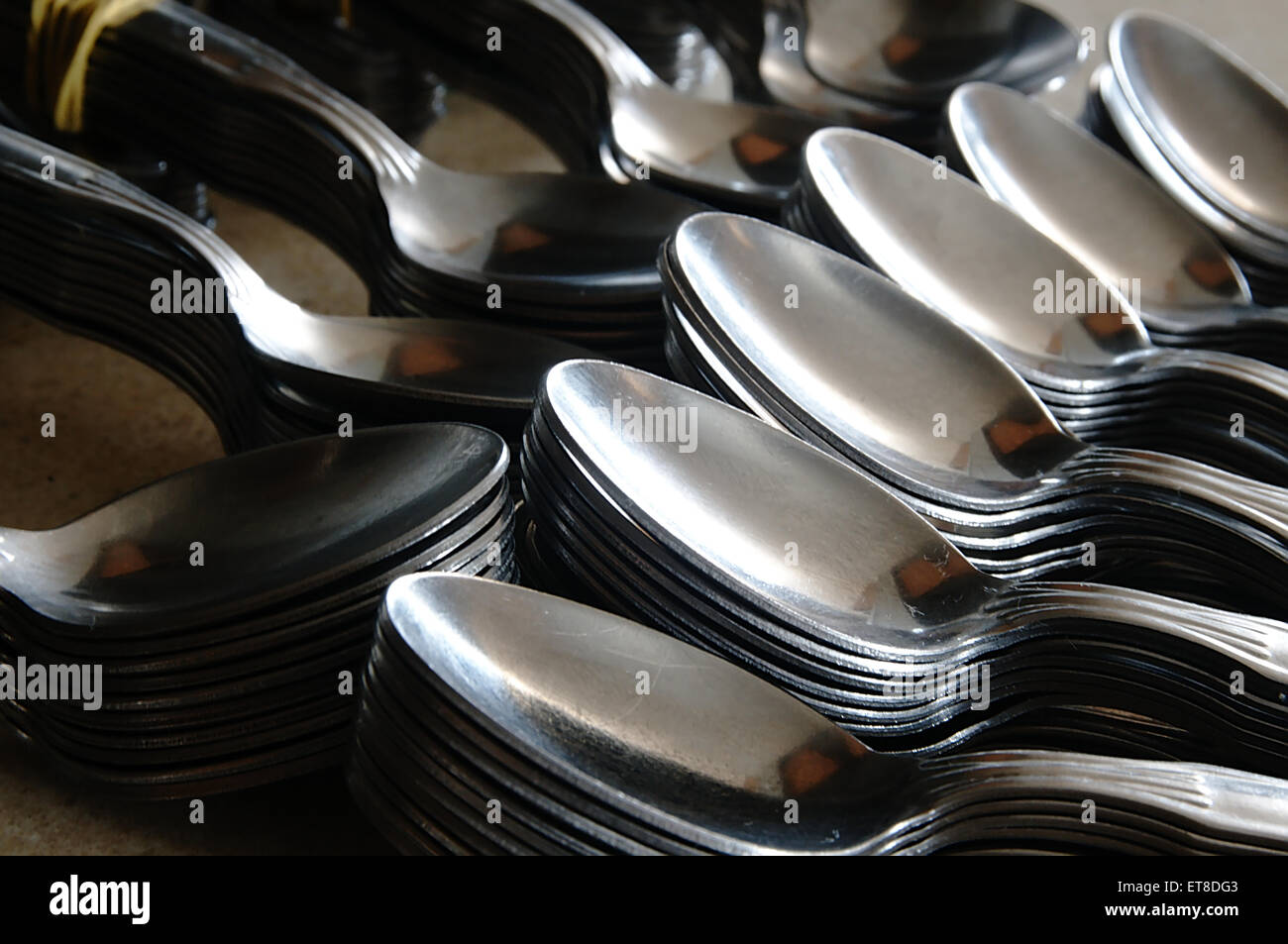 Metal spoons lying on the kitchen table in the daylight Stock Photo - Alamy