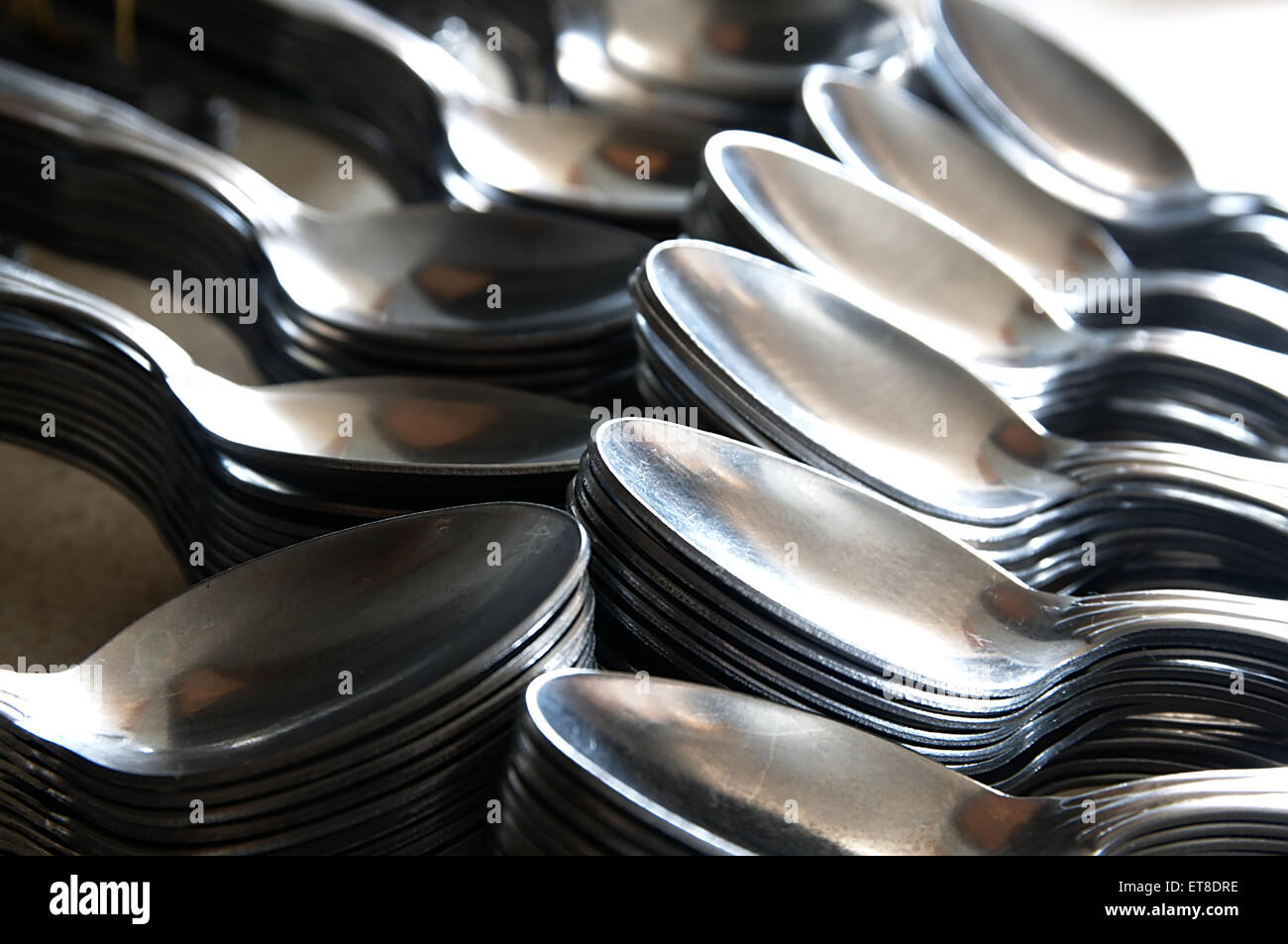 Metal spoons lying on the kitchen table in the daylight Stock Photo - Alamy
