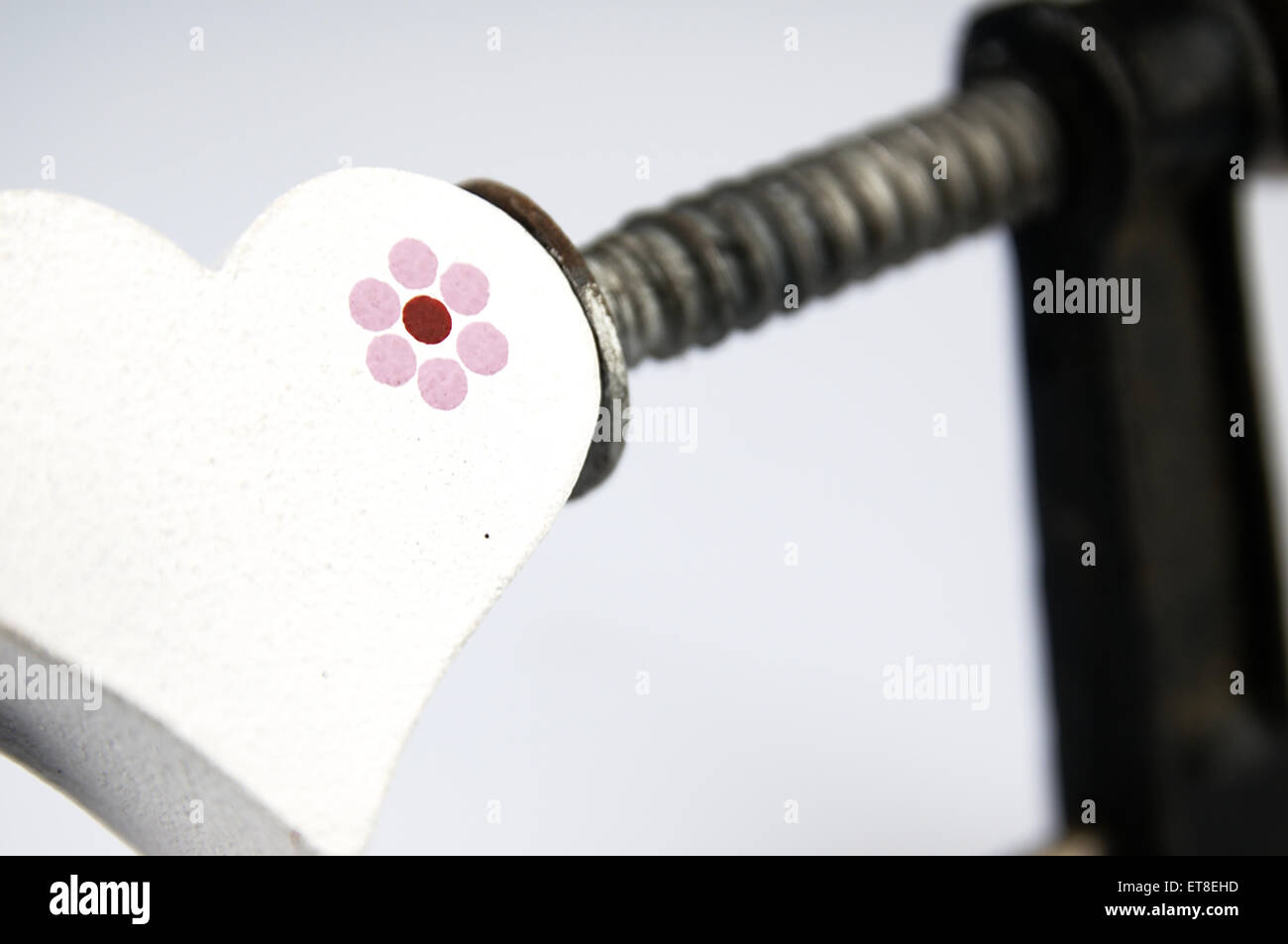 White heart and carpenter clamp. The idea for the display of a heart ...