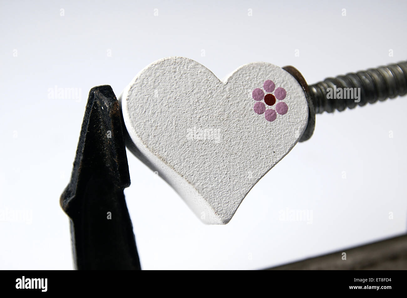 White heart and carpenter clamp. The idea for the display of a heart ...