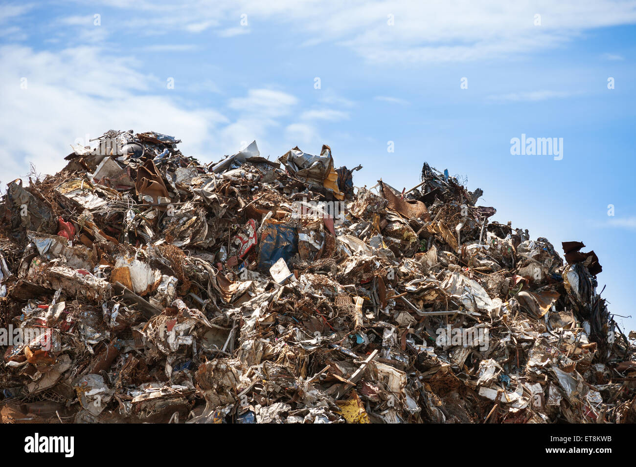 Scrap metal ready for recycling over blue sky Stock Photo - Alamy