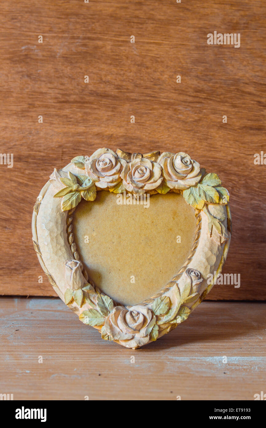 Heart Frame of vintage on a wooden Stock Photo - Alamy