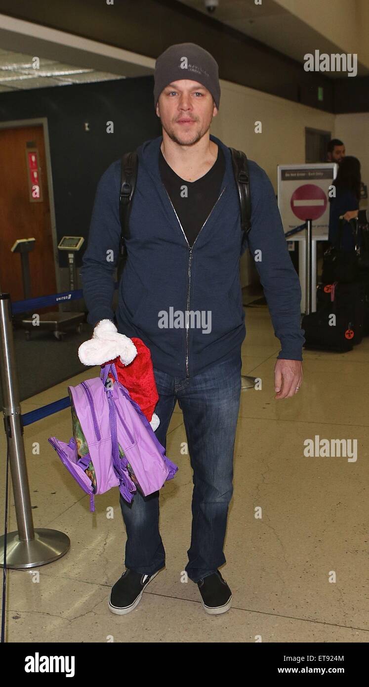 Matt Damon arrives at Los Angeles International Airport (LAX) carrying ...