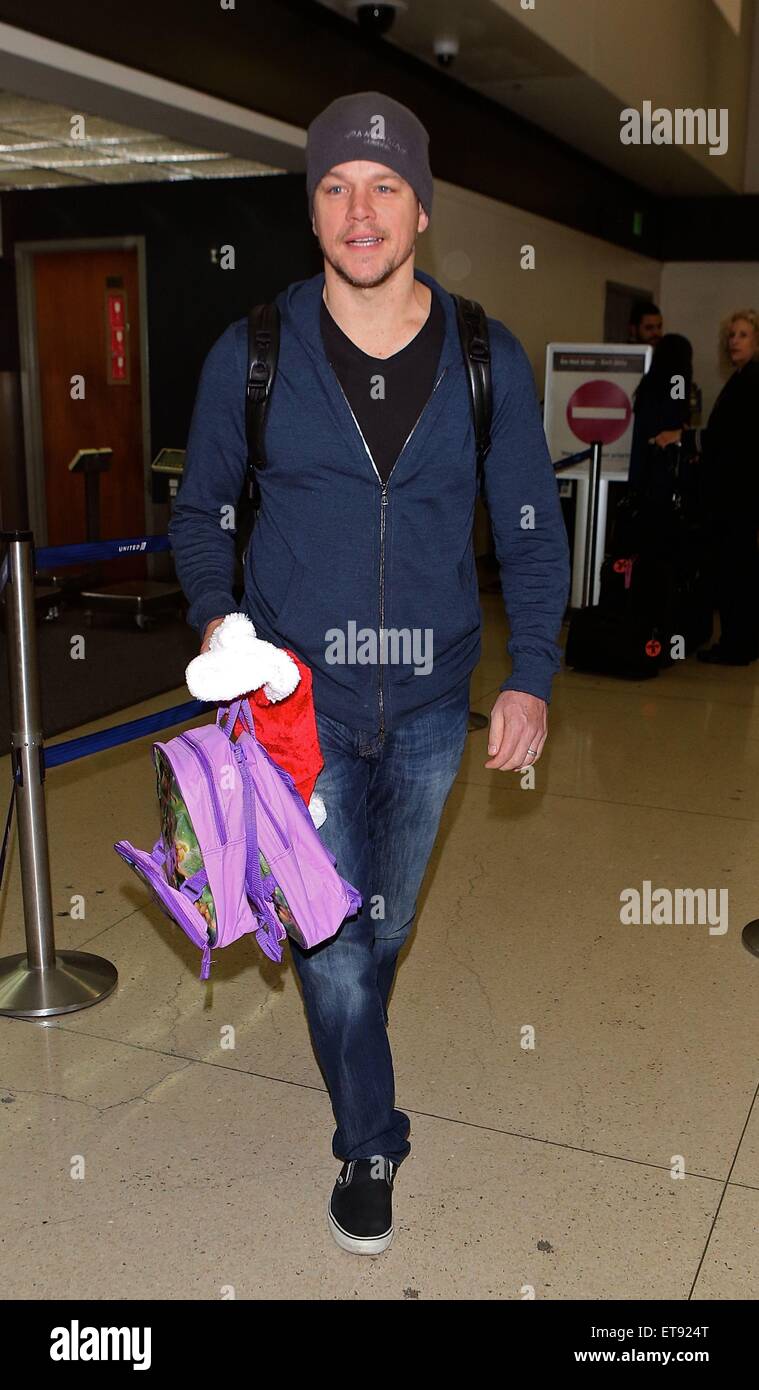 Matt Damon arrives at Los Angeles International Airport (LAX) carrying ...