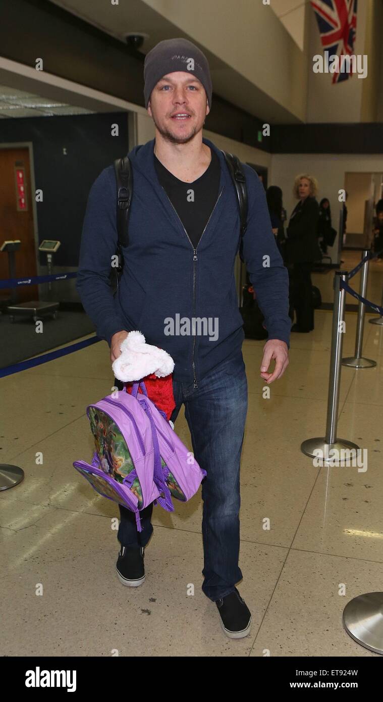 Matt Damon arrives at Los Angeles International Airport (LAX) carrying ...