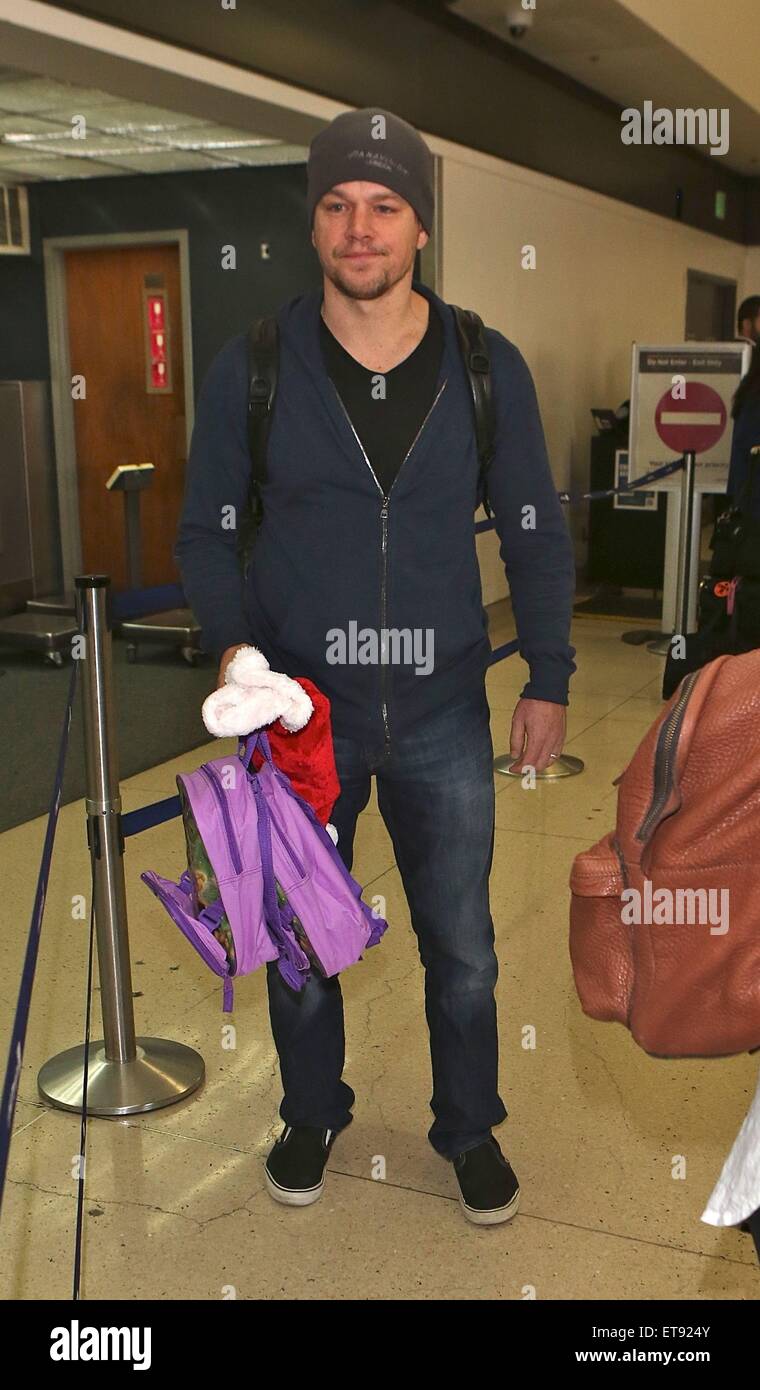 Matt Damon arrives at Los Angeles International Airport (LAX) carrying ...