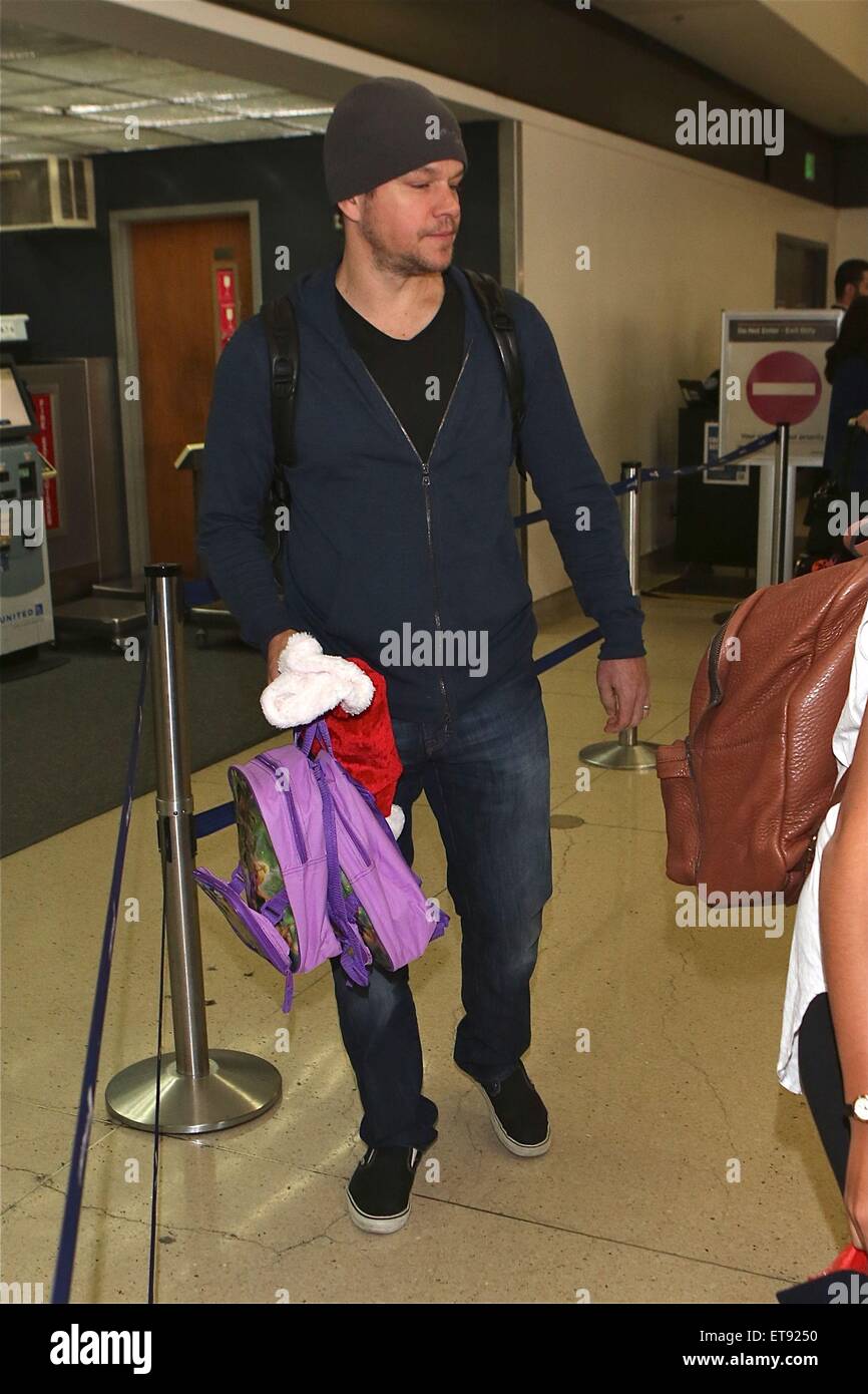 Matt Damon arrives at Los Angeles International Airport (LAX) carrying ...