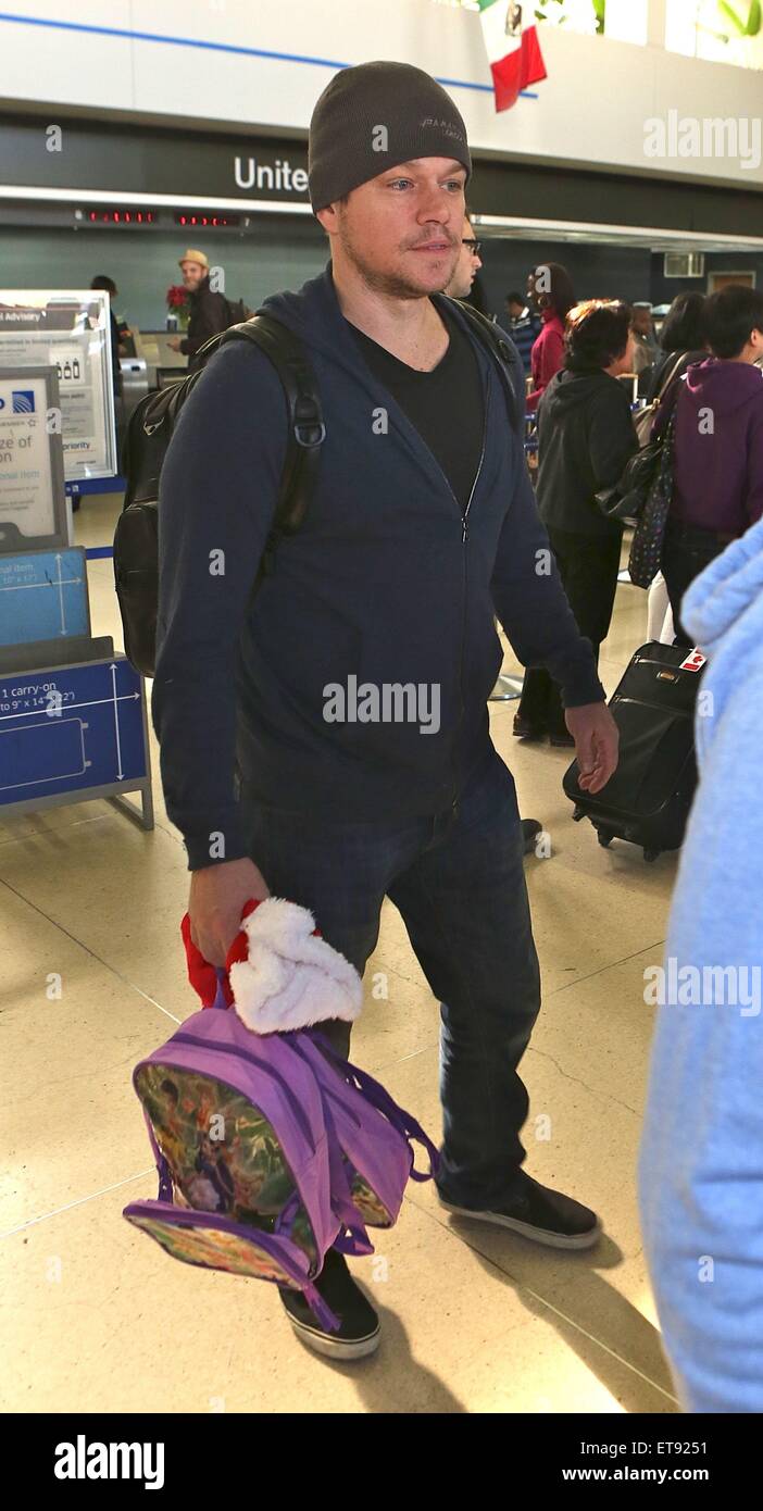 Matt Damon arrives at Los Angeles International Airport (LAX) carrying ...