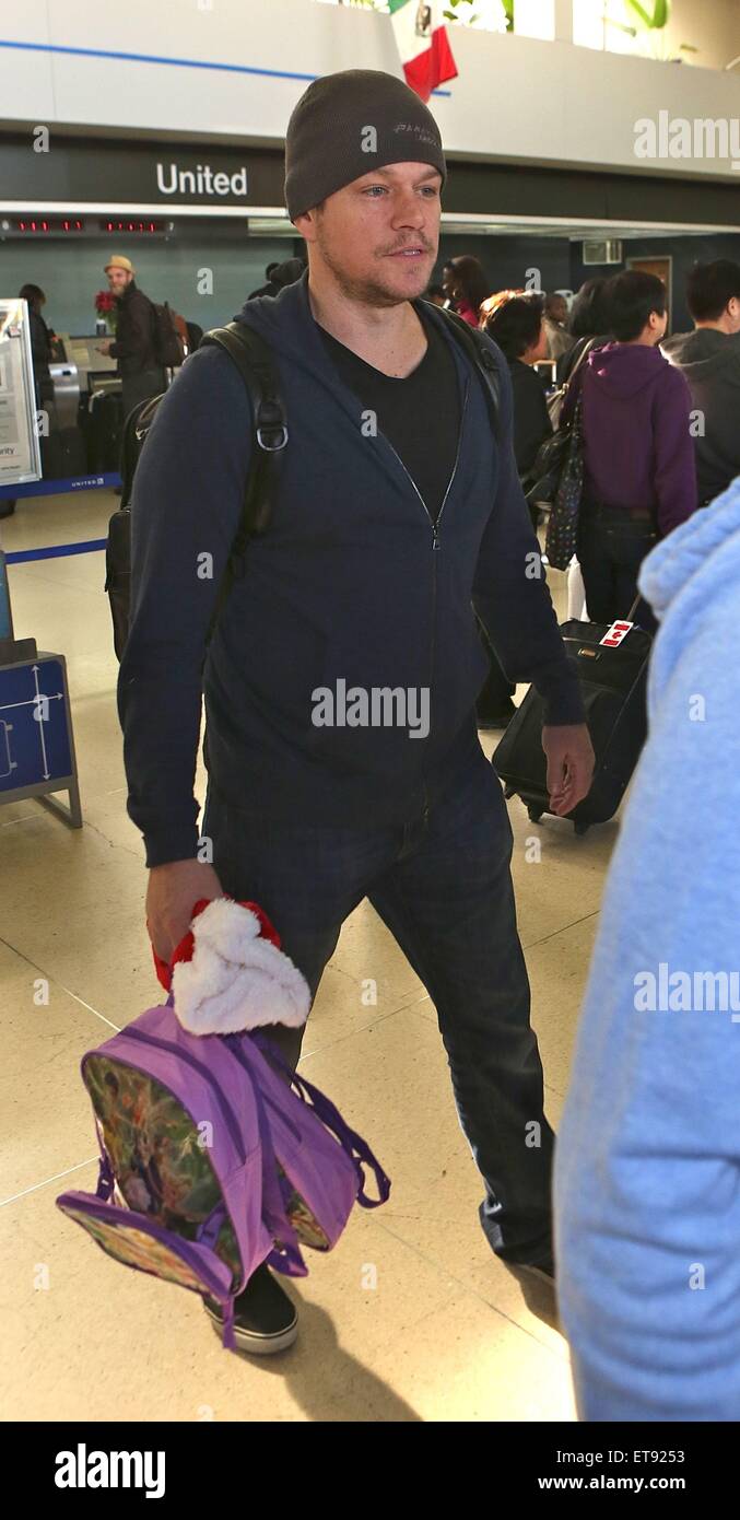 Matt Damon arrives at Los Angeles International Airport (LAX) carrying ...