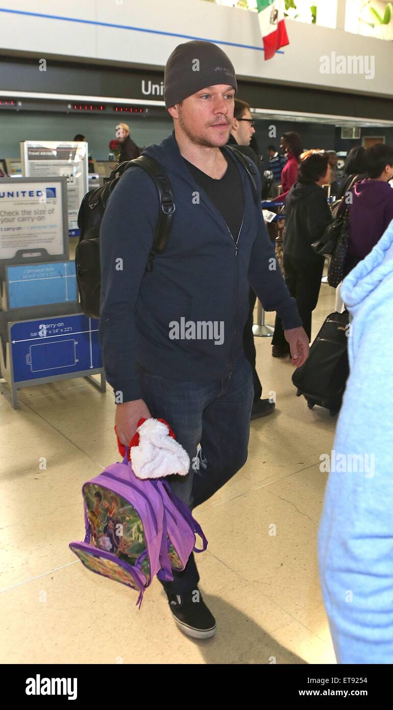 Matt Damon arrives at Los Angeles International Airport (LAX) carrying ...