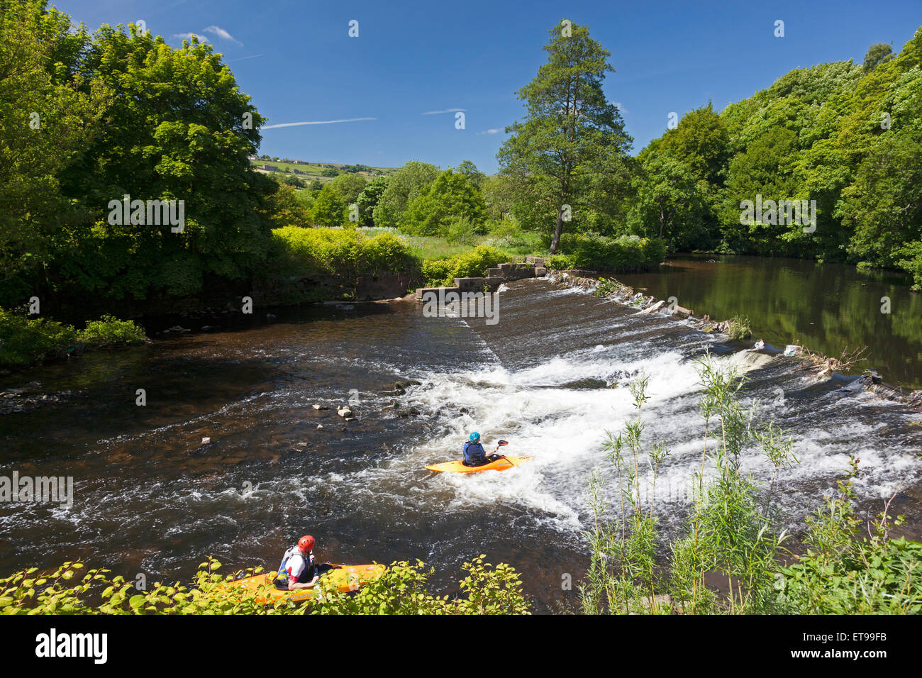 Kayakers negotiating weir on the River Calder, Sowerby Bridge, West ...